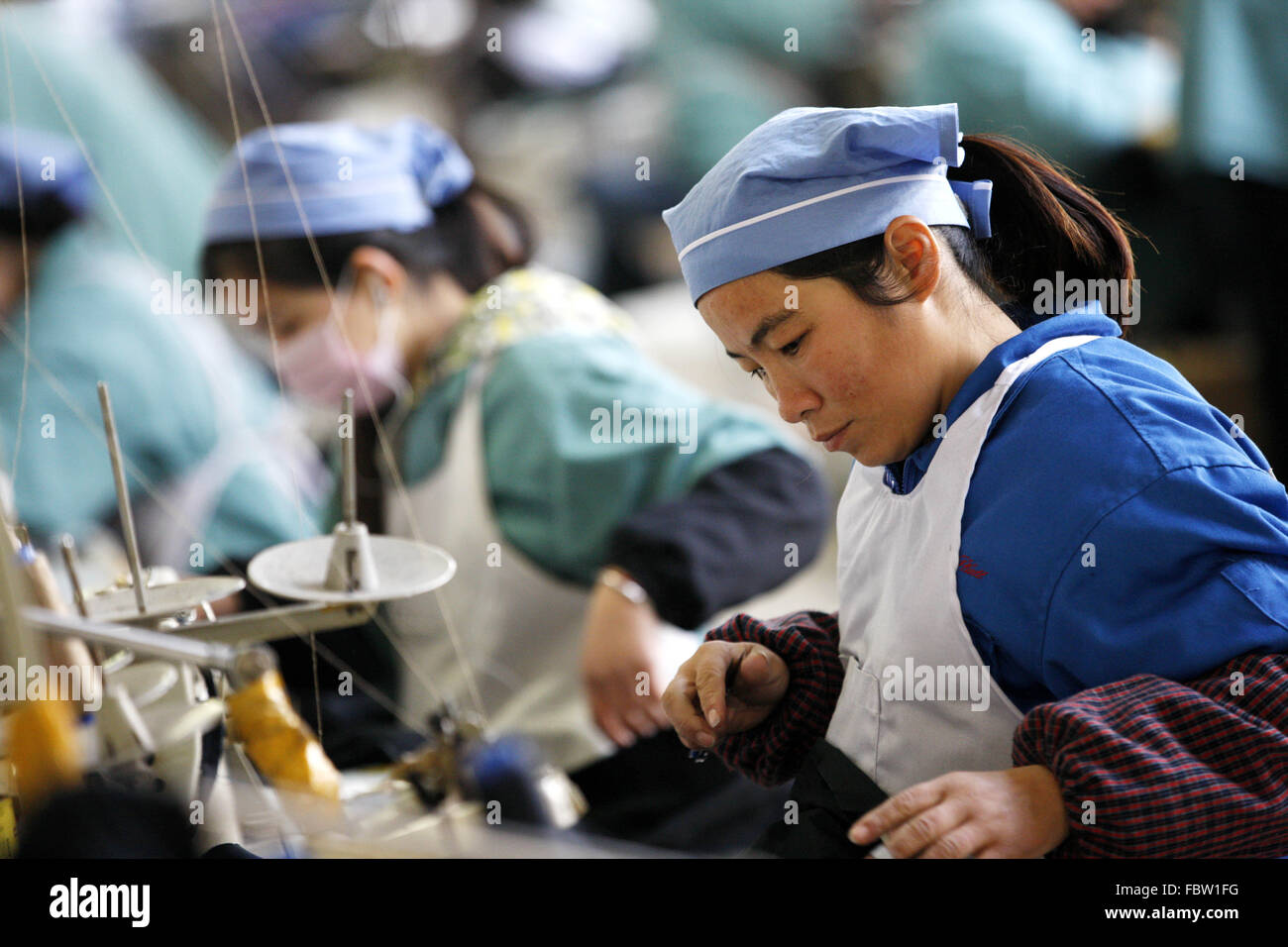 Female labours works at a cloth factory in Huaibei city, Anhui province ...