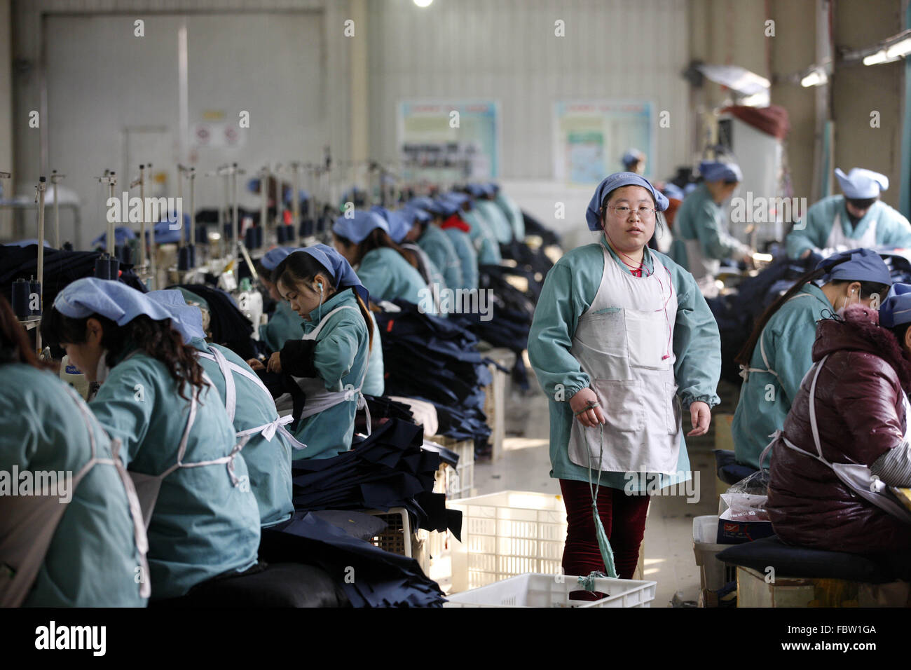 Female labours works at a cloth factory in Huaibei city, Anhui province ...