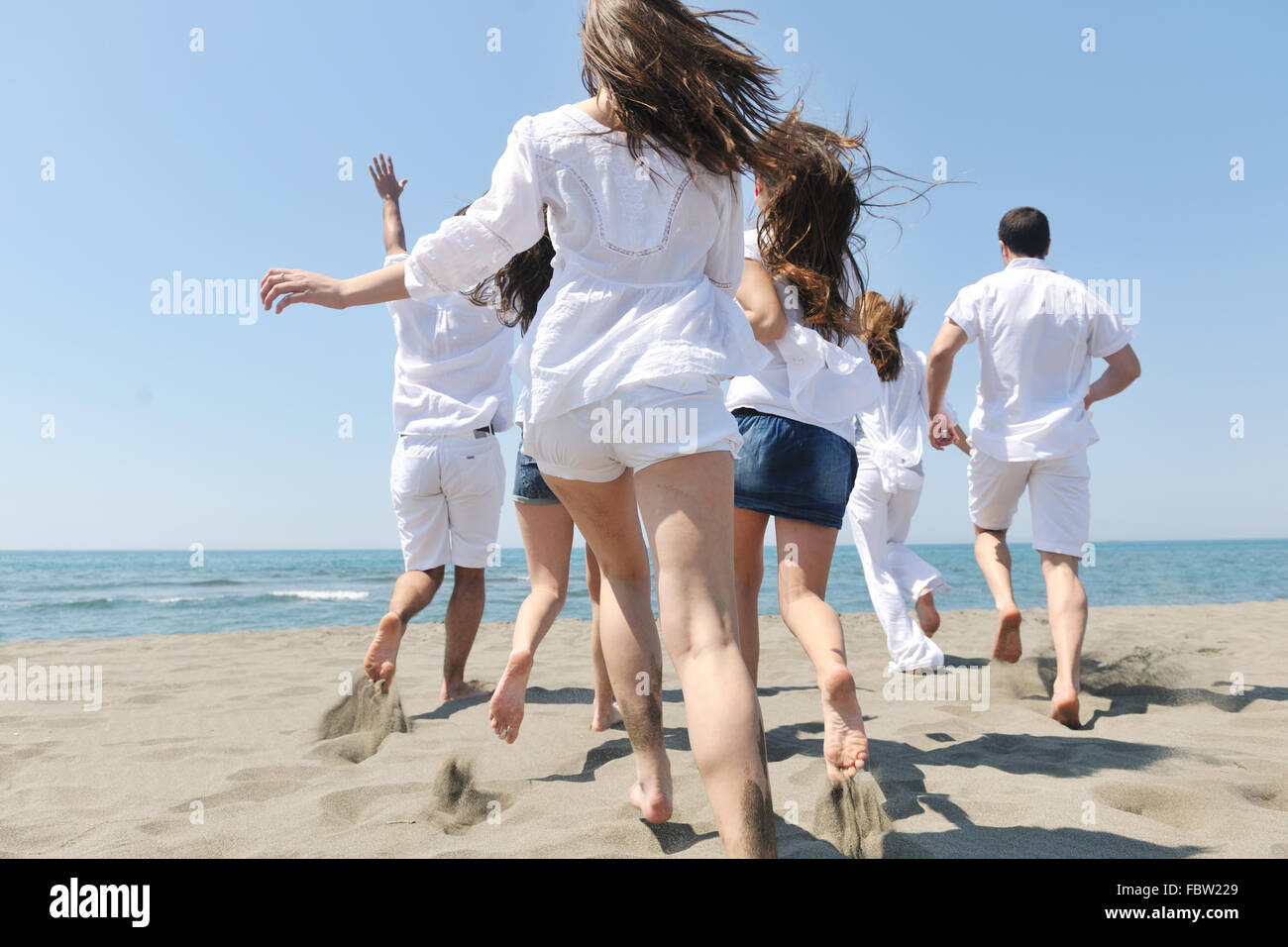 happy people group have fun and running on beach Stock Photo - Alamy