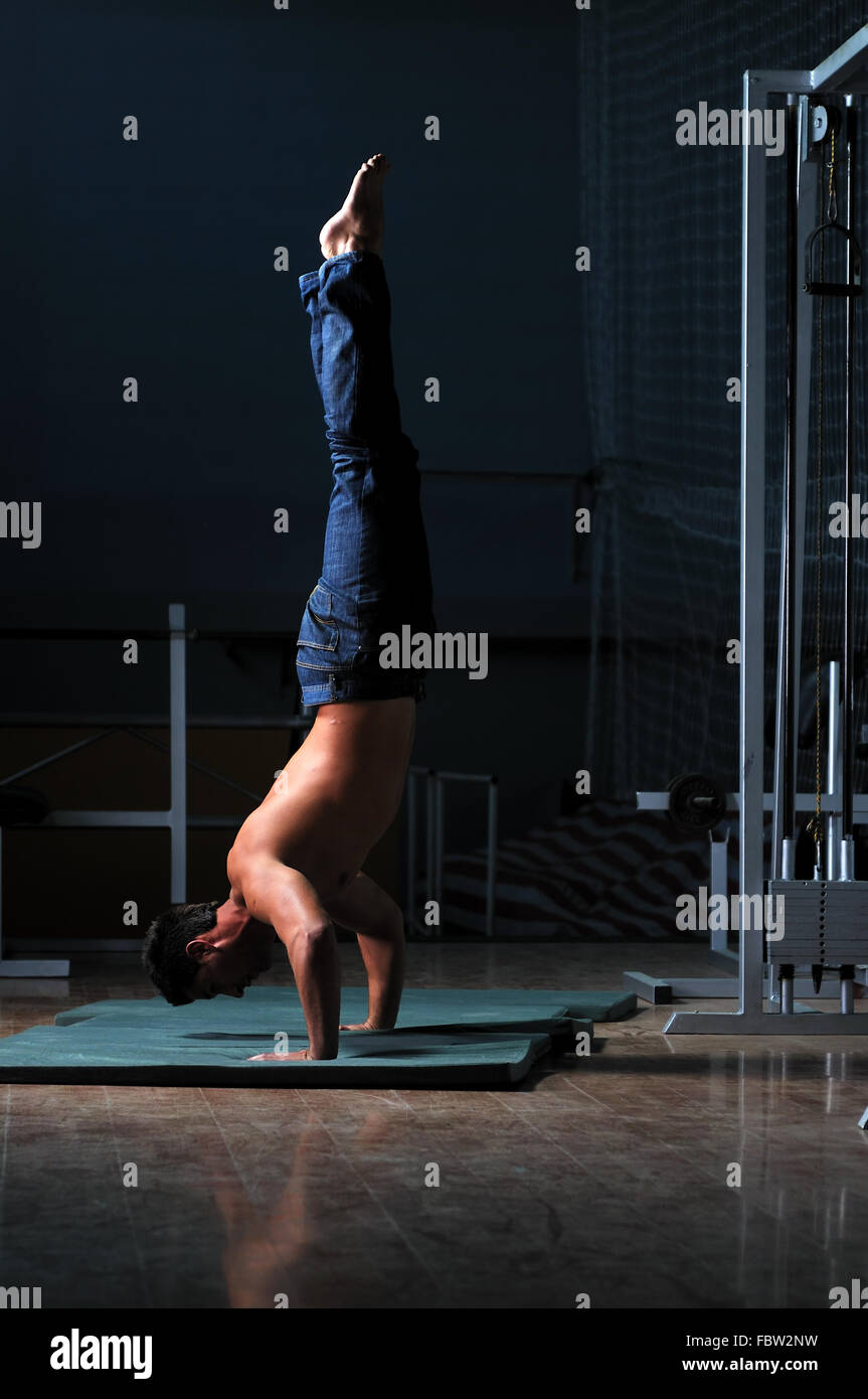 young man performing handstand in fitness studio Stock Photo - Alamy