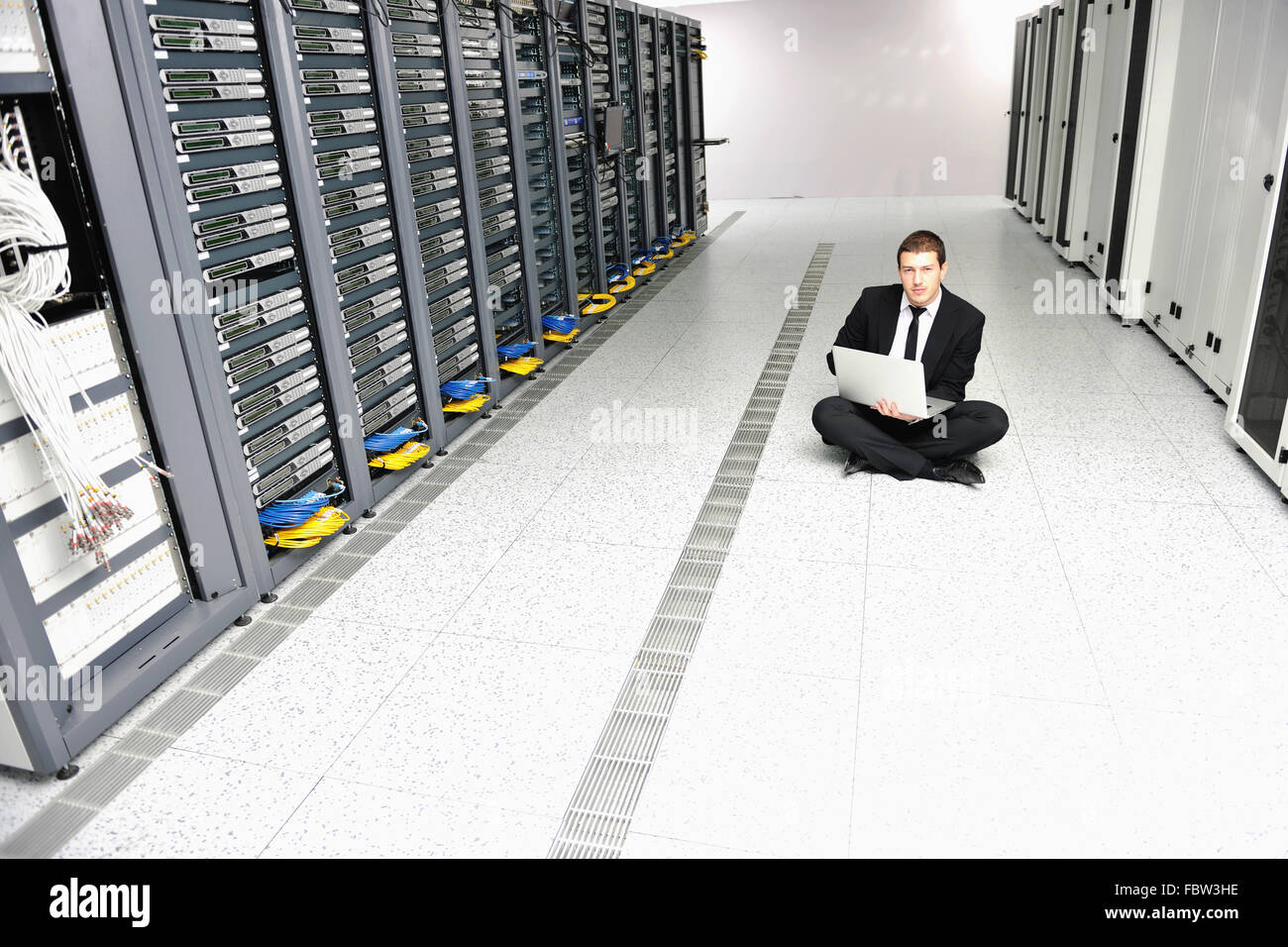 businessman with laptop in network server room Stock Photo - Alamy