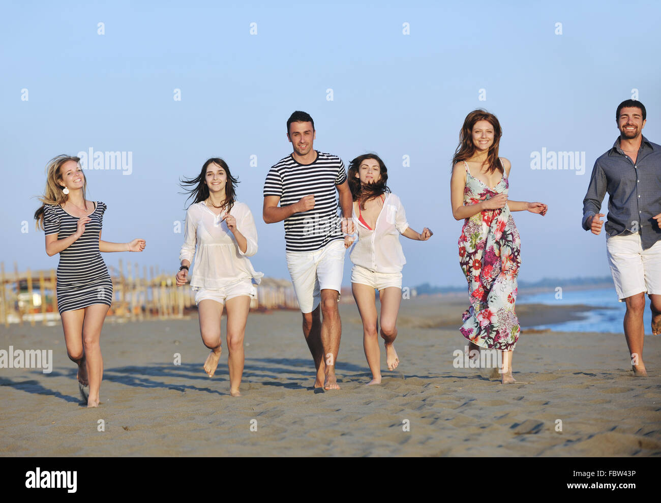 happy young people group have fun on beach Stock Photo - Alamy
