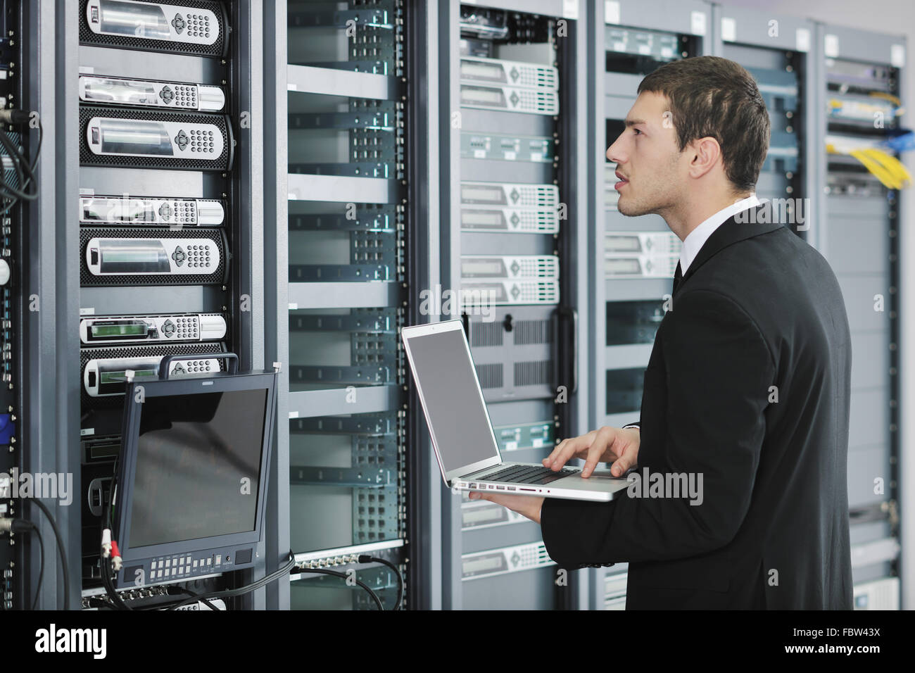 businessman with laptop in network server room Stock Photo - Alamy
