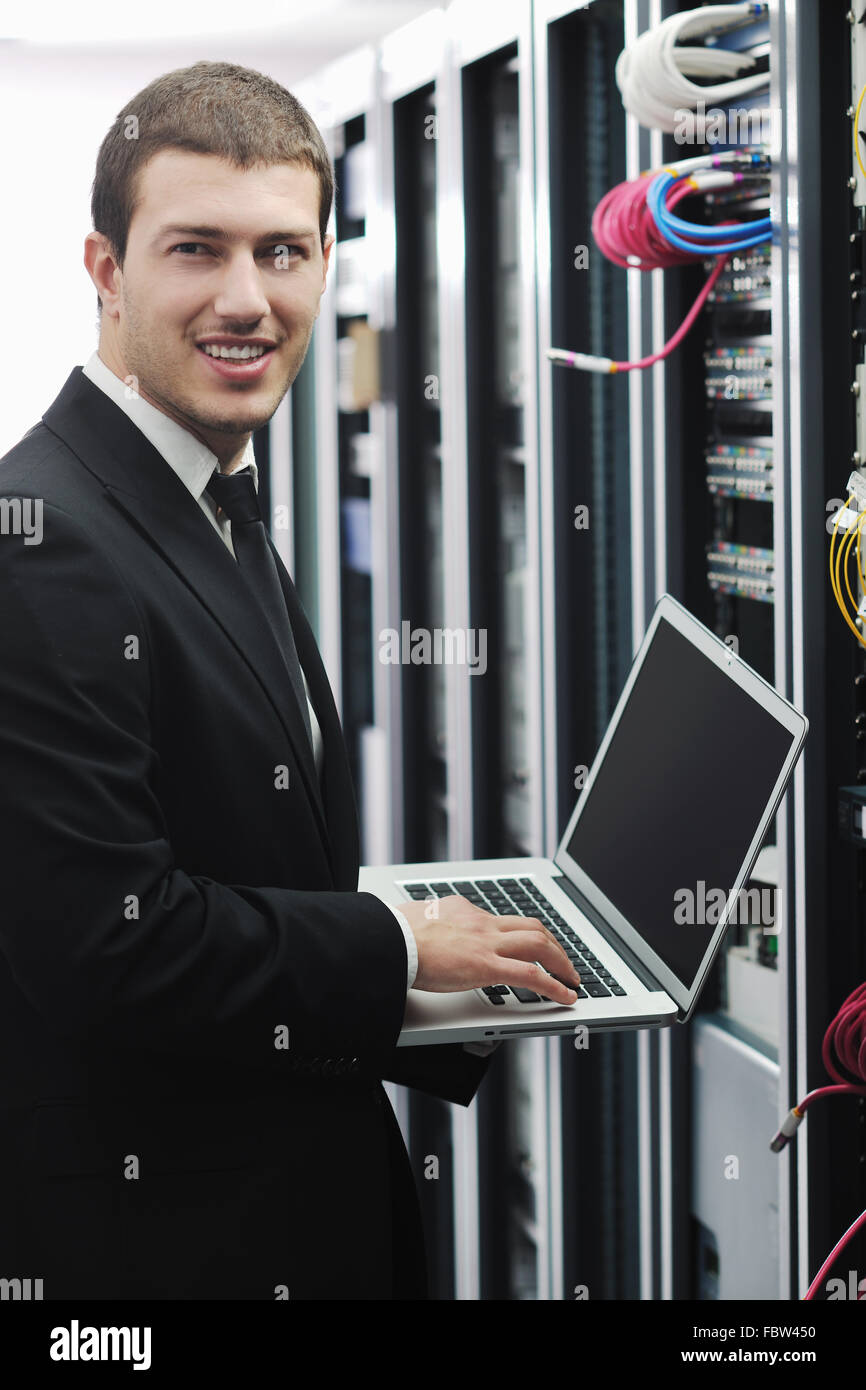 businessman with laptop in network server room Stock Photo - Alamy