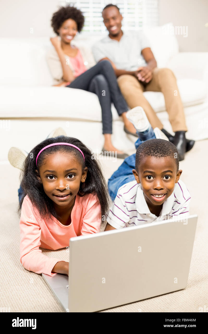 Happy kids using laptop pc Stock Photo - Alamy
