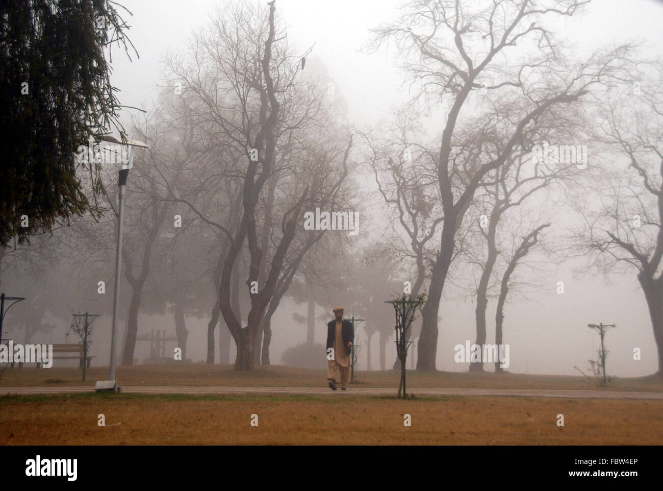 Islamabad. 19th Jan, 2016. A man walks during heavy fog in Islamabad ...