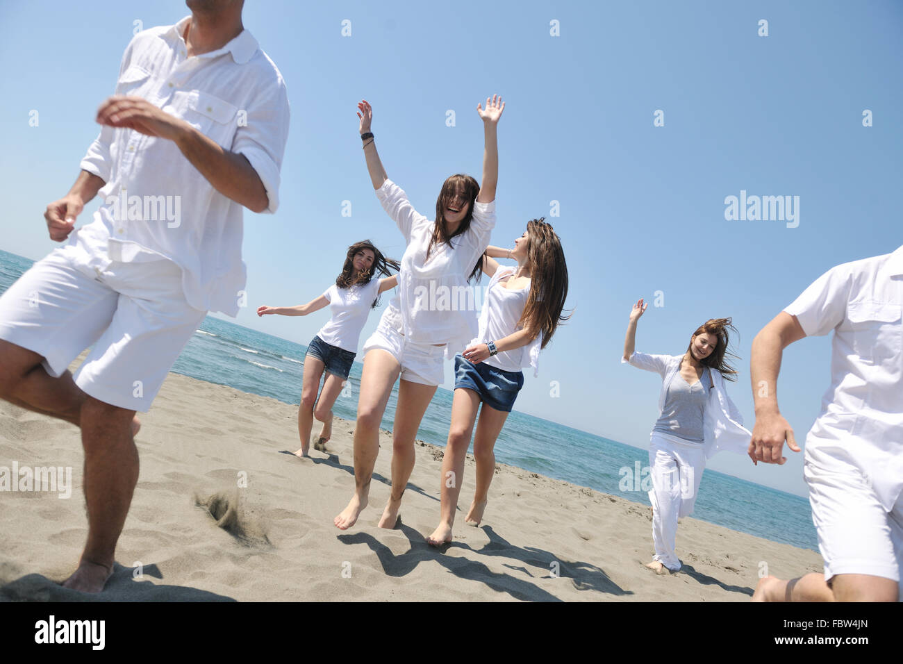 happy people group have fun and running on beach Stock Photo - Alamy