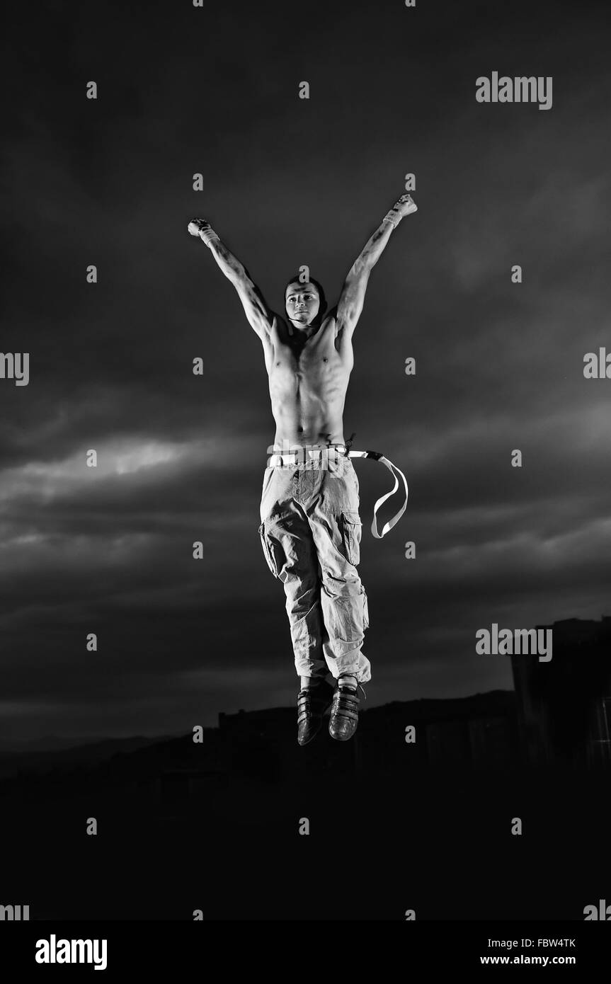 young man dancing and jumping on top of the building Stock Photo - Alamy