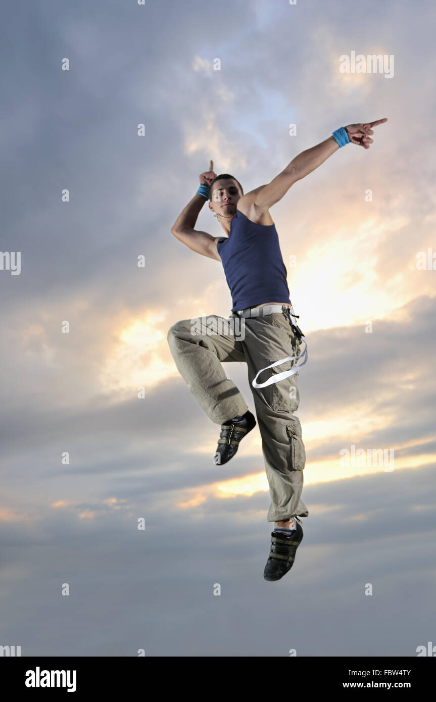 young man dancing and jumping on top of the building Stock Photo - Alamy