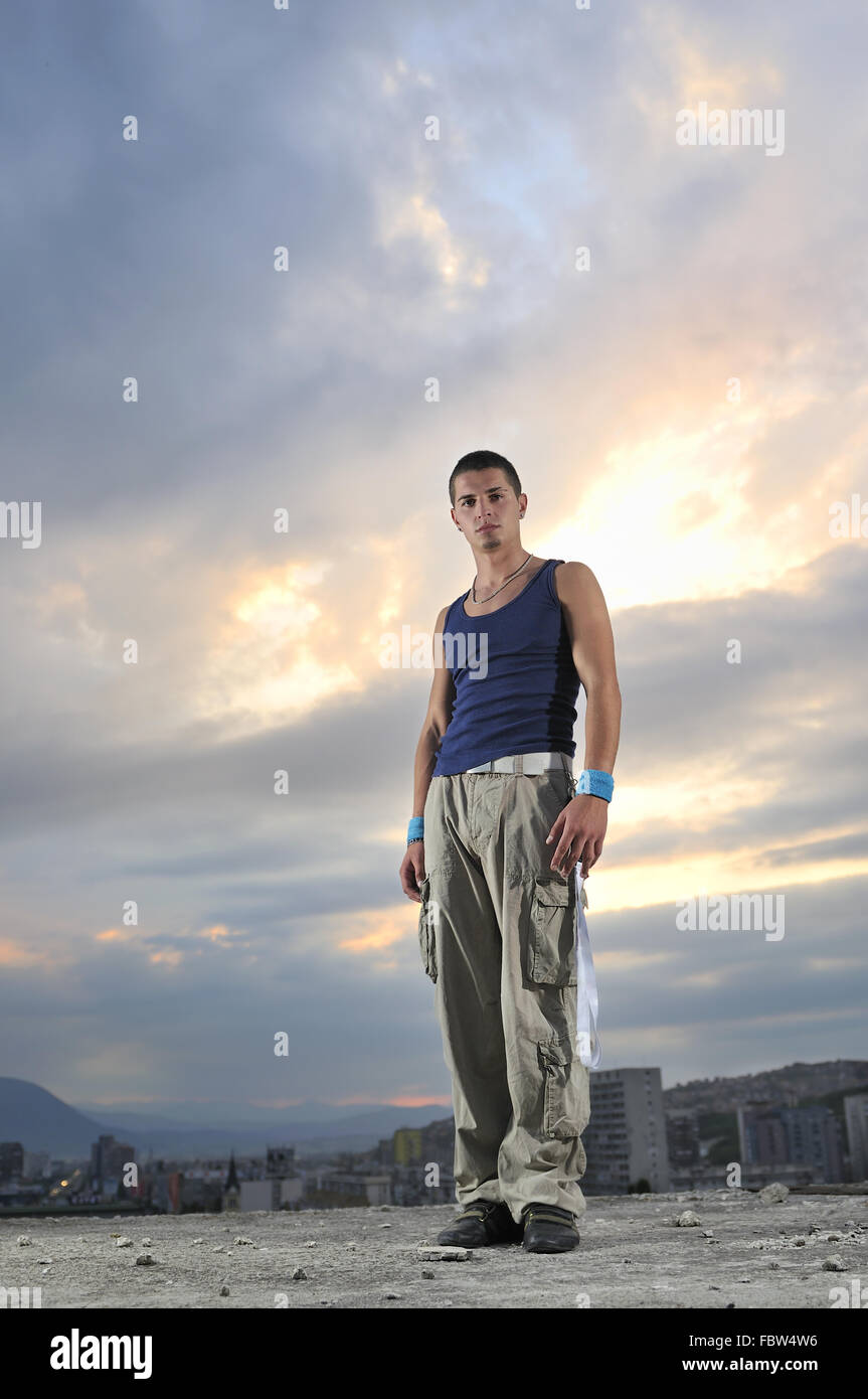young man dancing and jumping on top of the building Stock Photo - Alamy