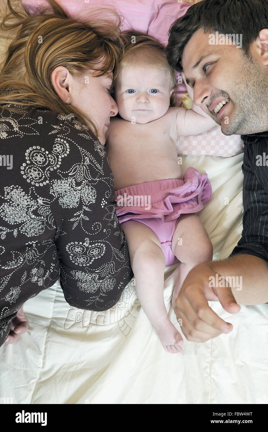 portrait of young family with cute little babby Stock Photo - Alamy