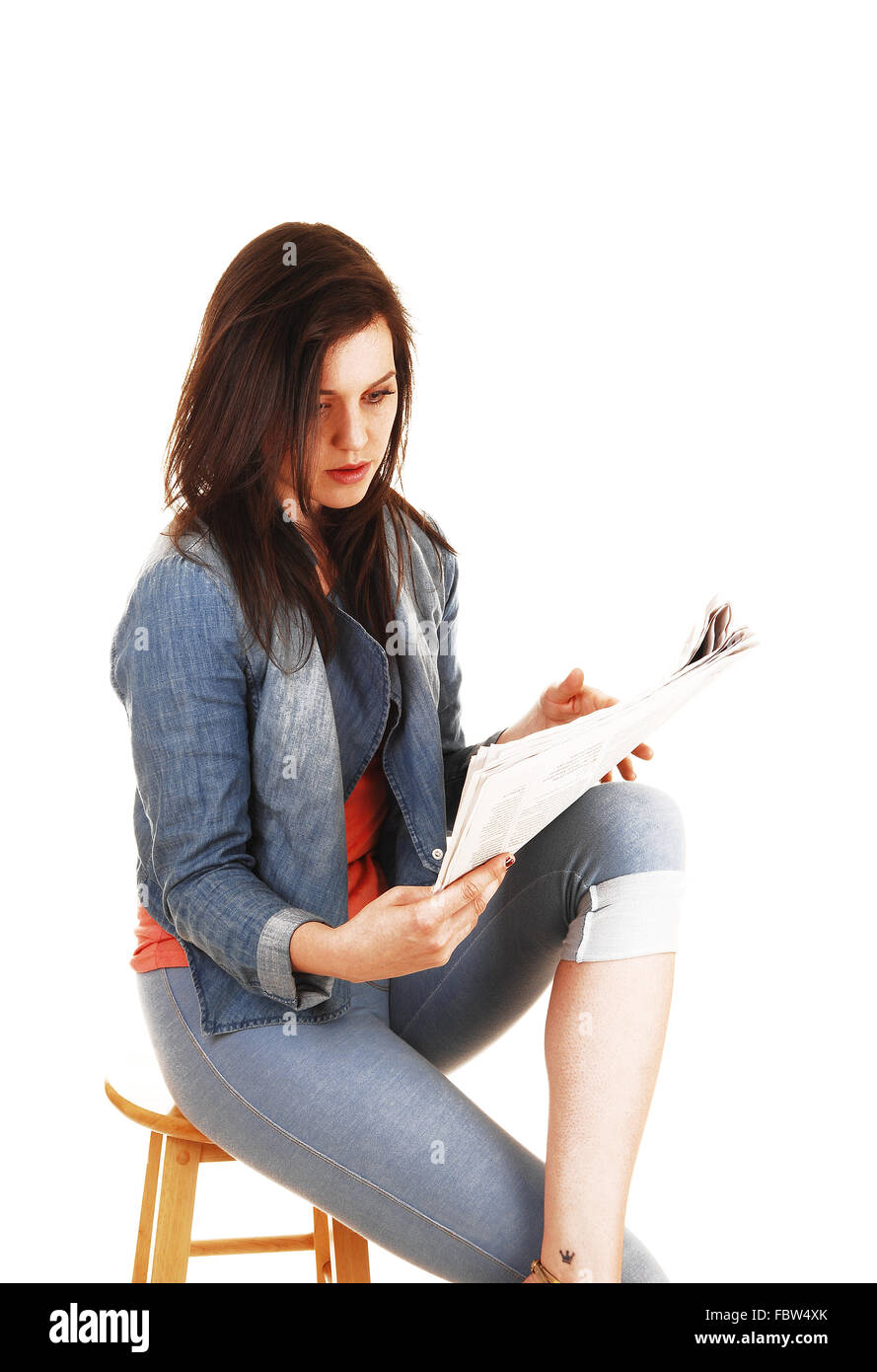 Girl reading the paper Stock Photo - Alamy