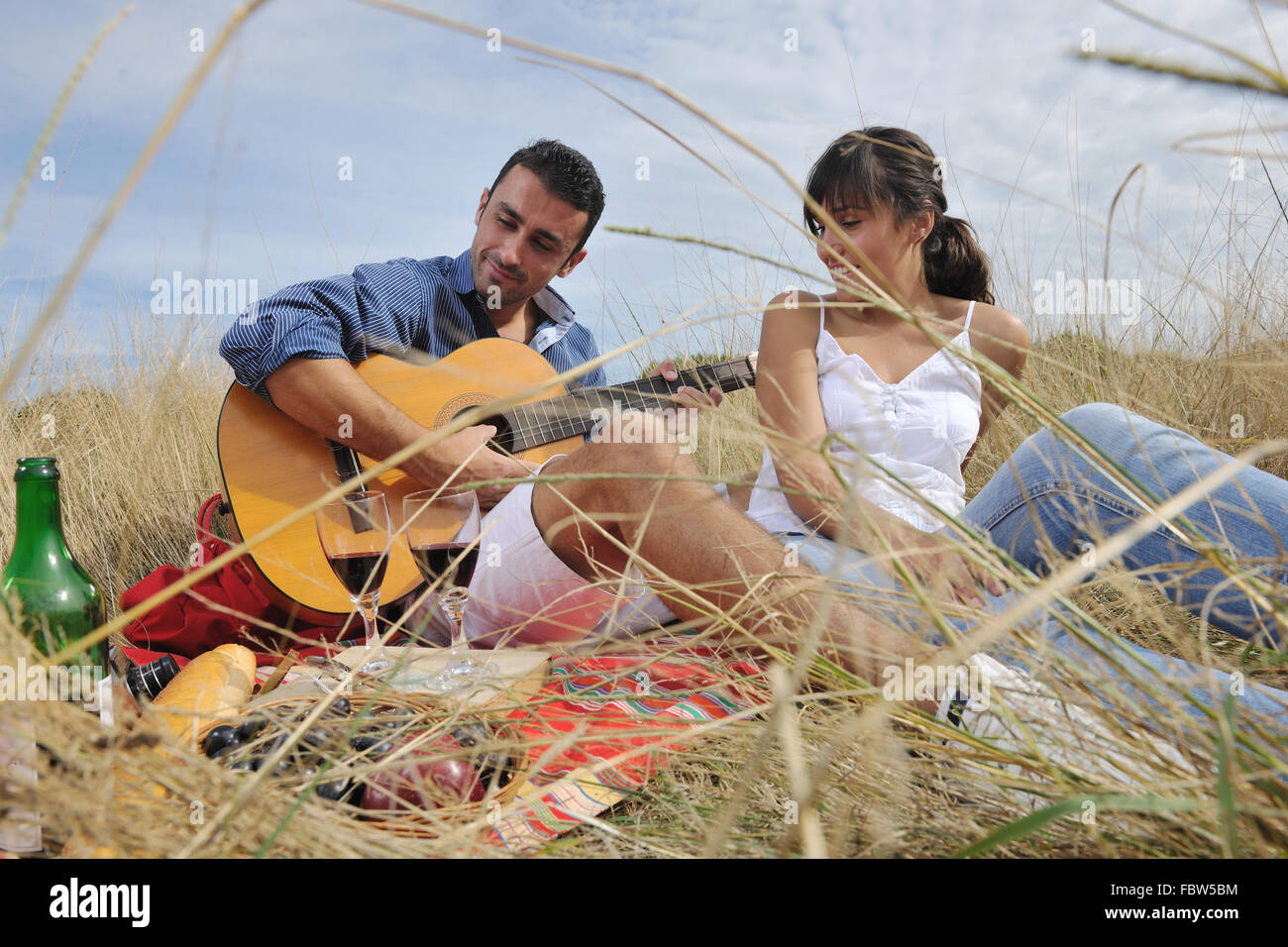 happy couple enjoying countryside picnic in long grass Stock Photo - Alamy