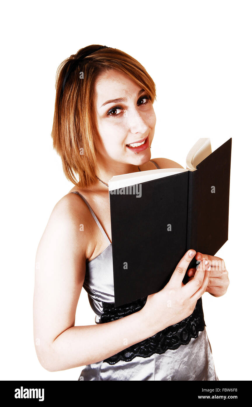 Girl looking over book Stock Photo - Alamy