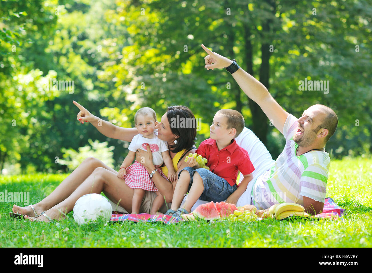 happy young couple with their children have fun at park Stock Photo - Alamy