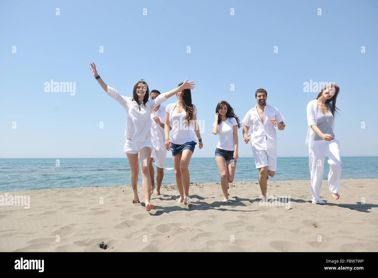 happy people group have fun and running on beach Stock Photo - Alamy