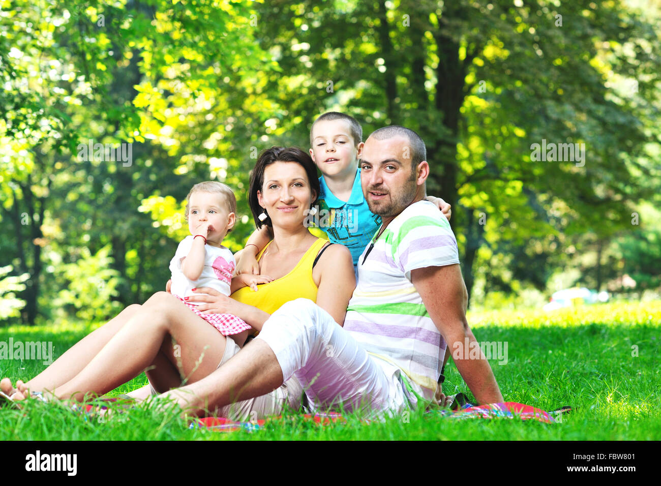 happy young couple with their children have fun at park Stock Photo - Alamy