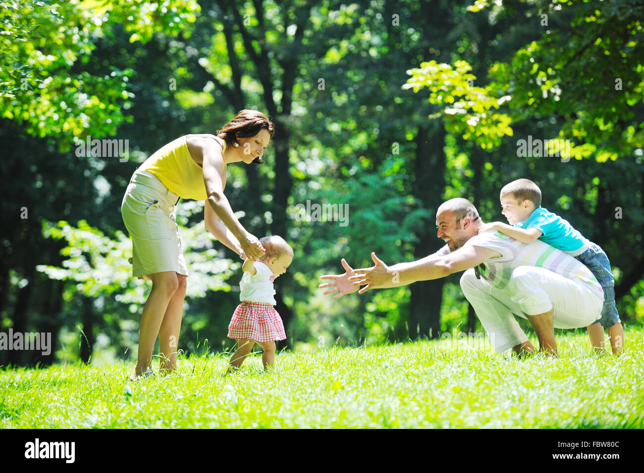 happy young couple with their children have fun at park Stock Photo - Alamy