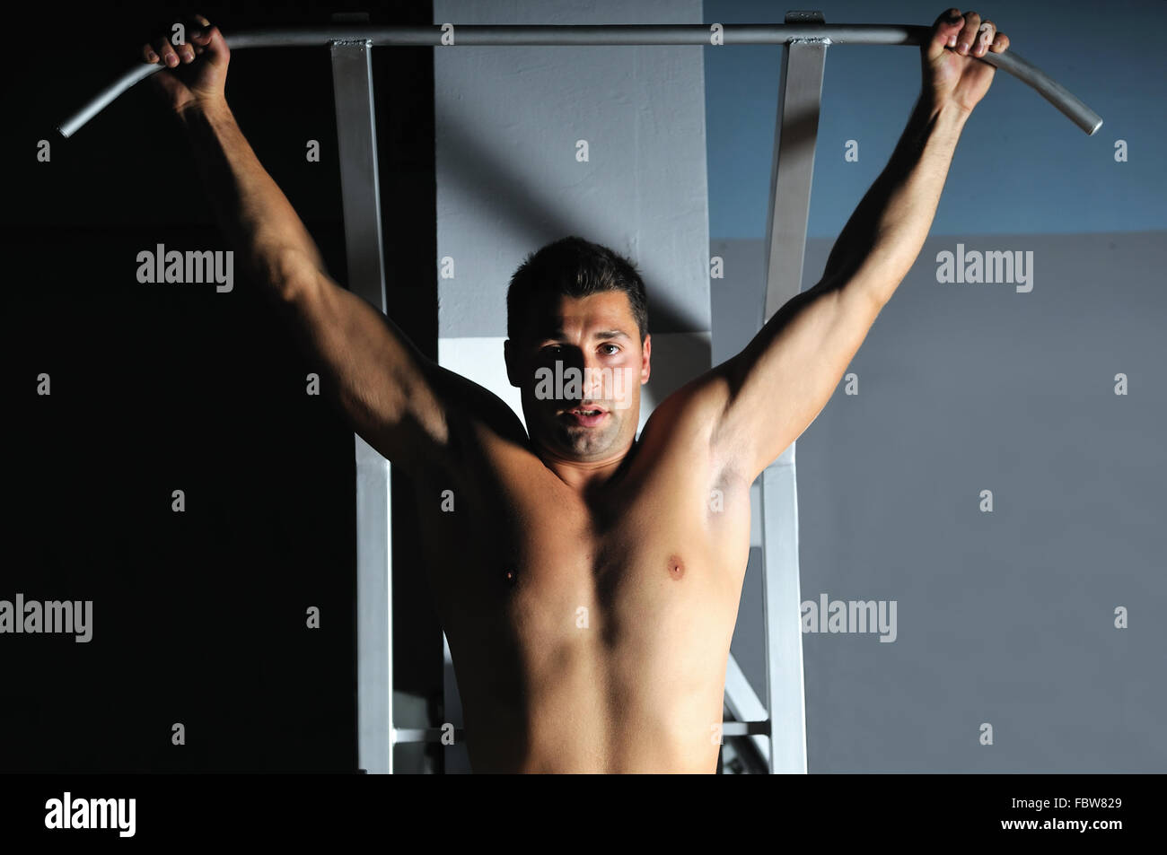 young man with strong arms working out in gym Stock Photo - Alamy