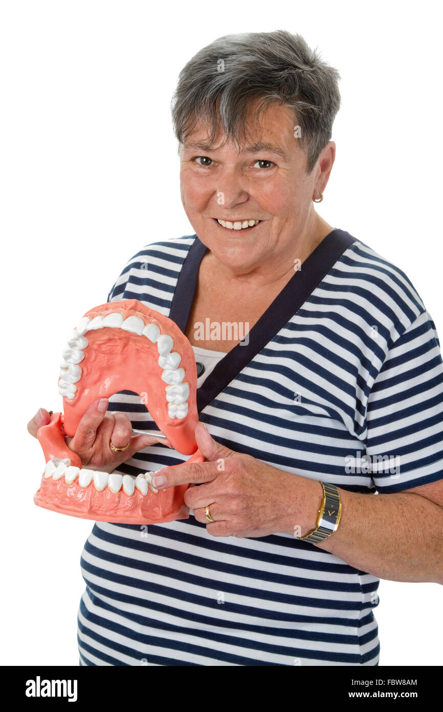 Senior woman pointing on tooth Stock Photo - Alamy