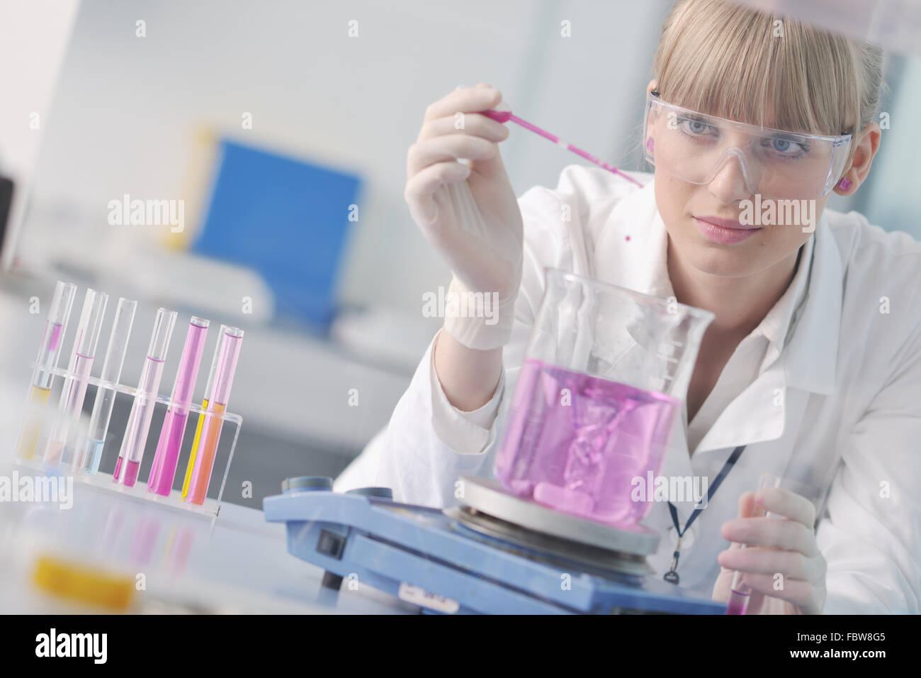female researcher holding up a test tube in lab Stock Photo - Alamy