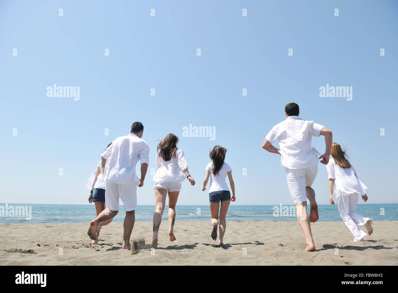 happy people group have fun and running on beach Stock Photo - Alamy
