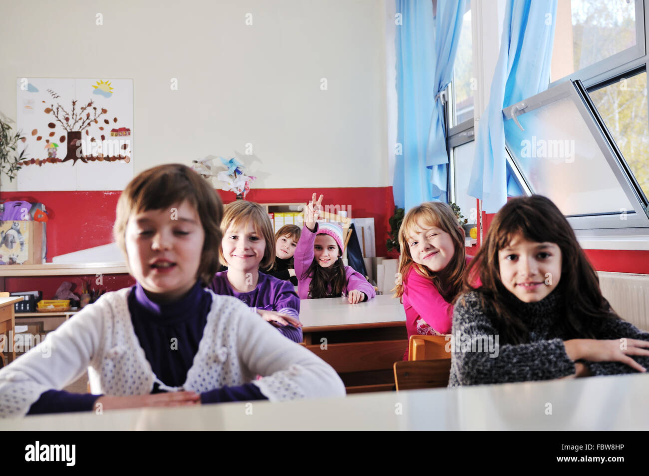happy kids with teacher in school classroom Stock Photo - Alamy
