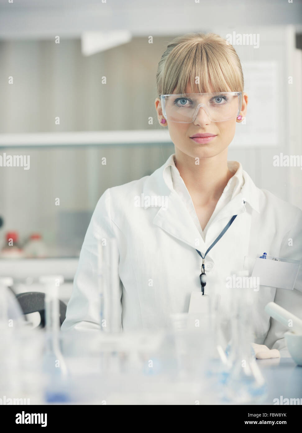 female researcher holding up a test tube in lab Stock Photo - Alamy