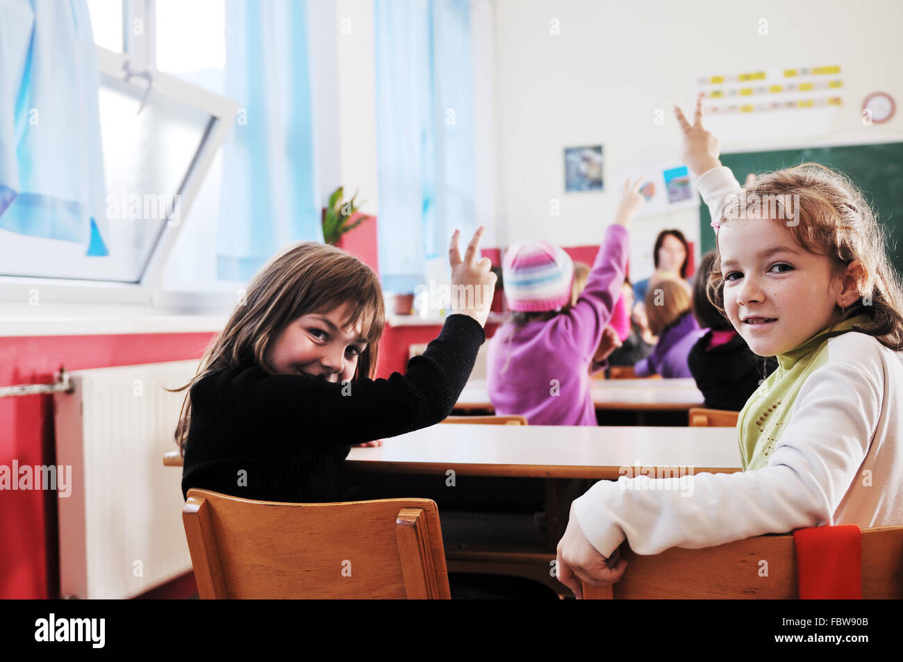 happy kids with teacher in school classroom Stock Photo - Alamy