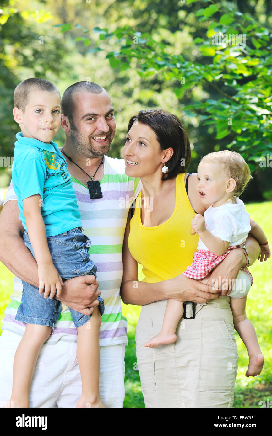 happy young couple with their children have fun at park Stock Photo - Alamy