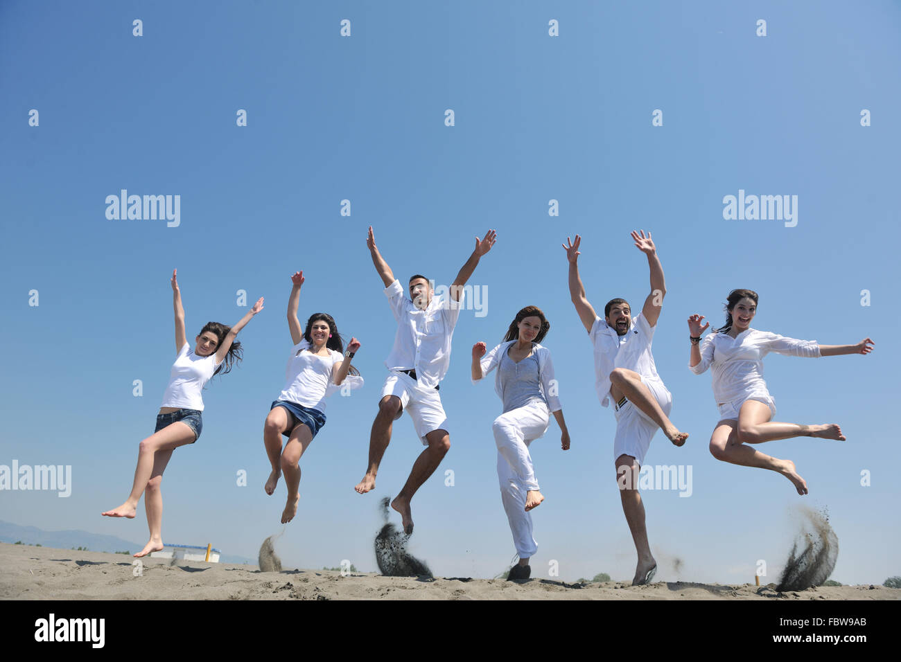 happy people group have fun and running on beach Stock Photo - Alamy
