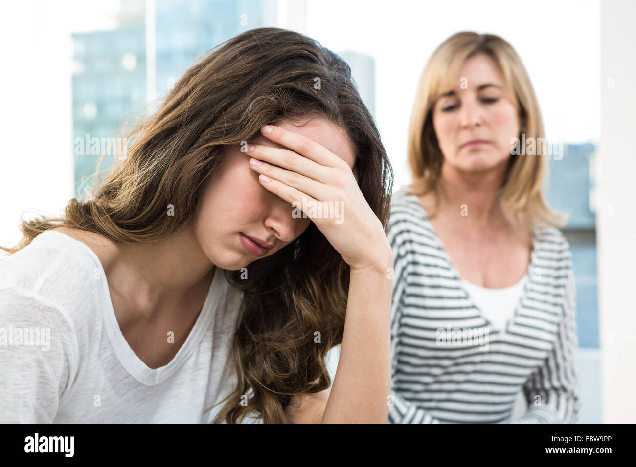 Sad daughter against mother Stock Photo - Alamy