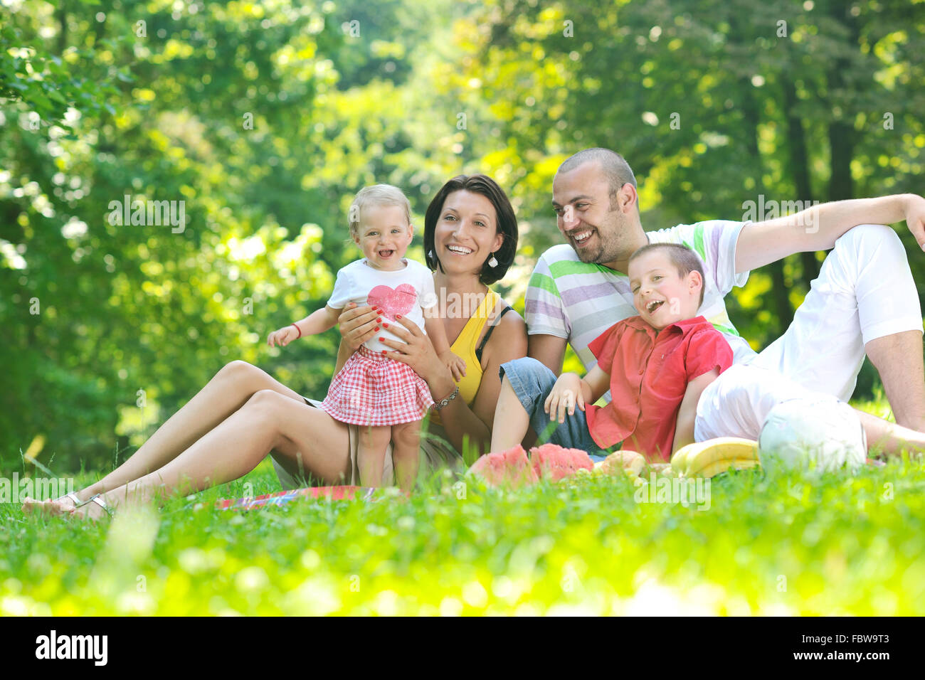 happy young couple with their children have fun at park Stock Photo - Alamy