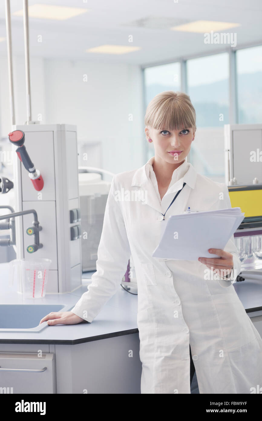 female researcher holding up a test tube in lab Stock Photo - Alamy