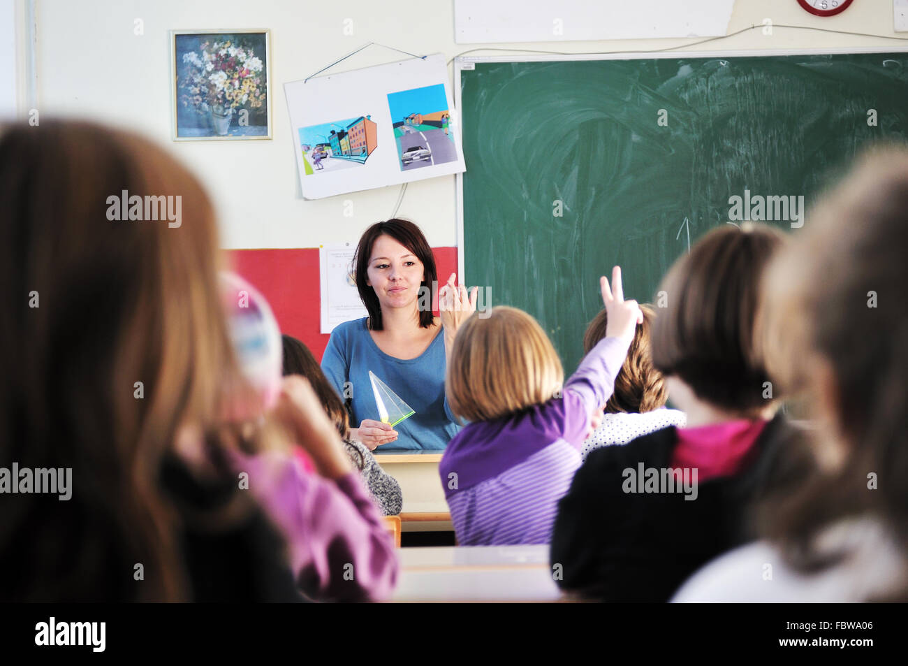 happy kids with teacher in school classroom Stock Photo - Alamy