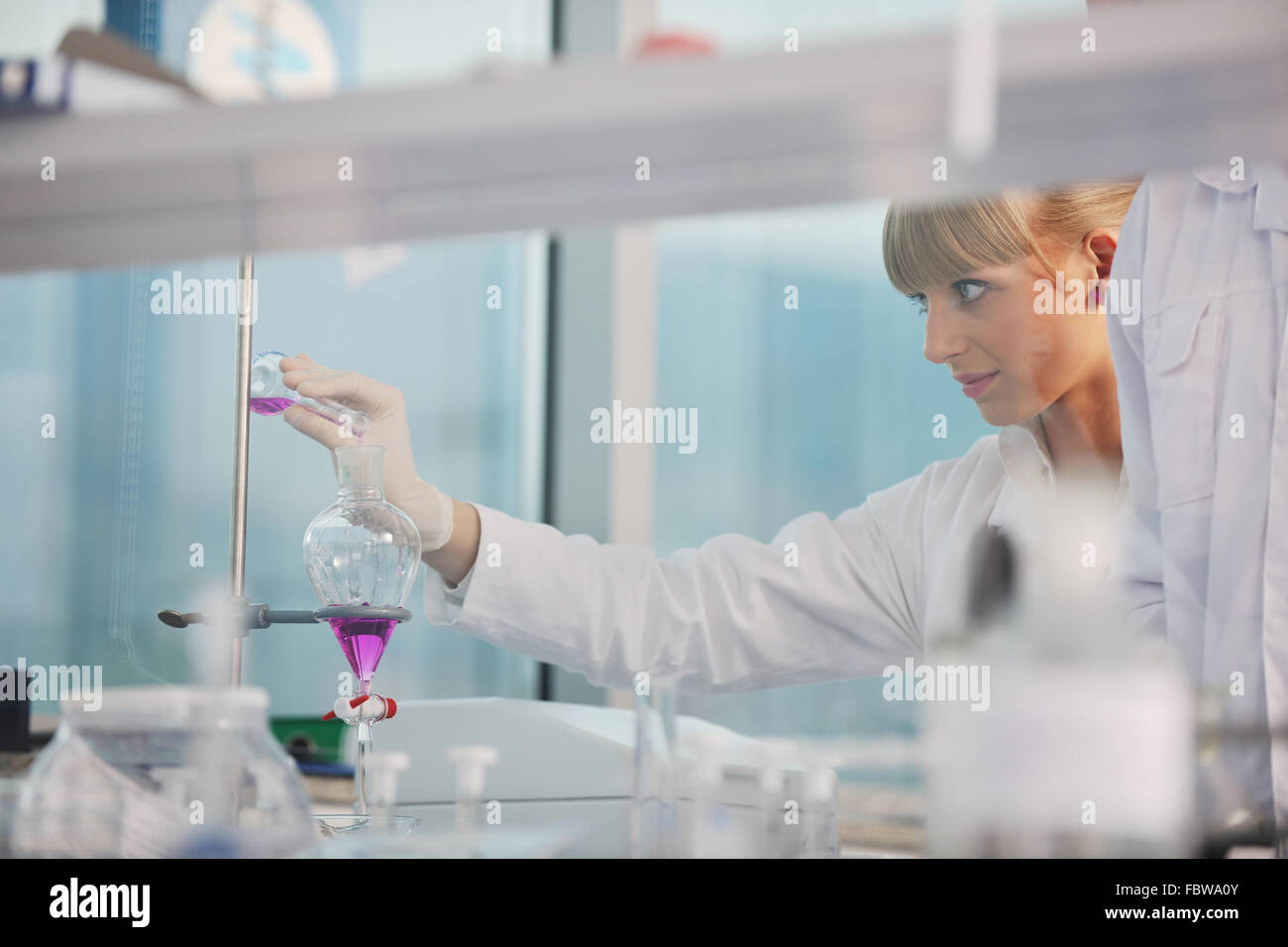 female researcher holding up a test tube in lab Stock Photo - Alamy