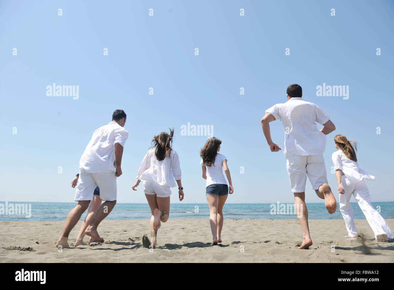 happy people group have fun and running on beach Stock Photo - Alamy
