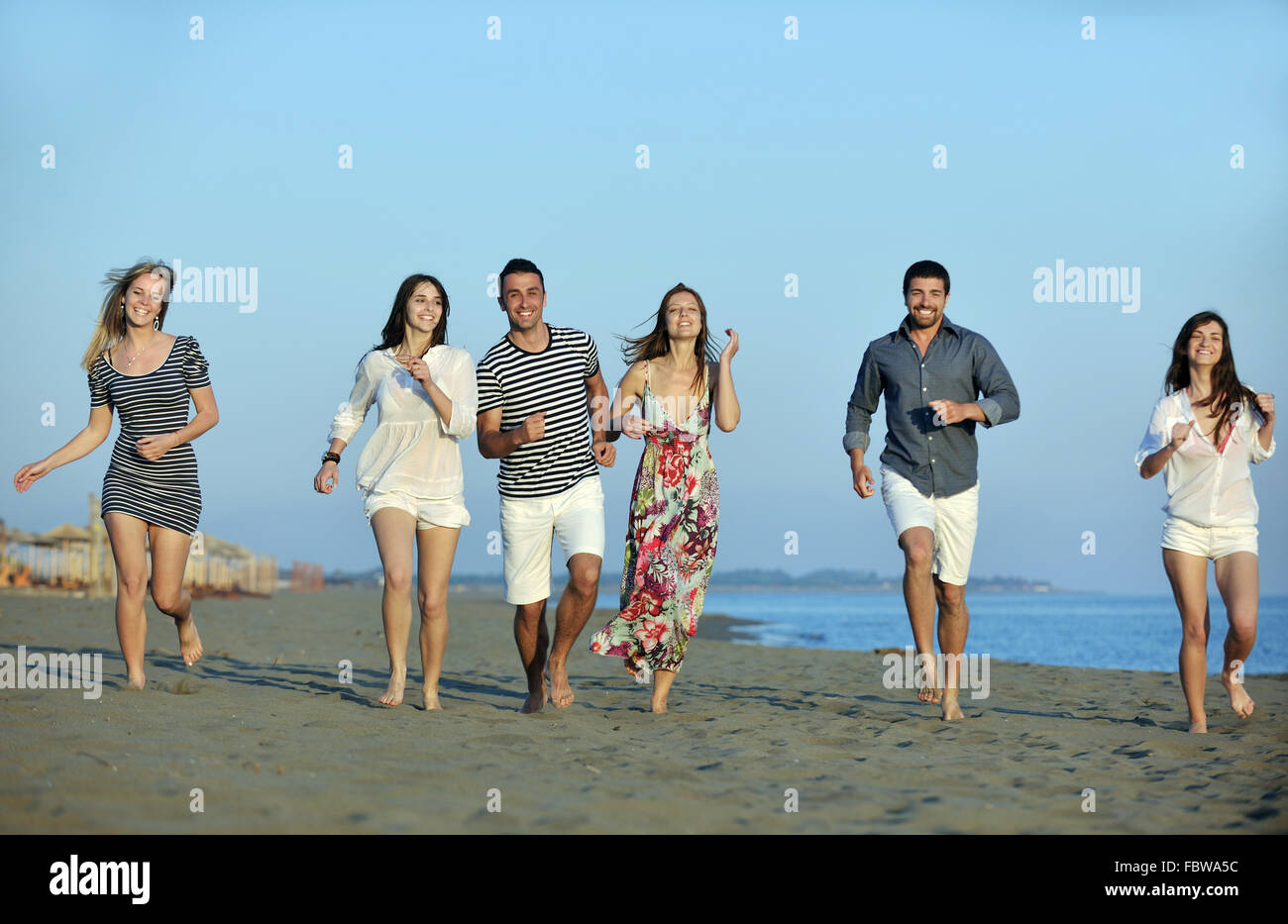 happy young people group have fun on beach Stock Photo - Alamy