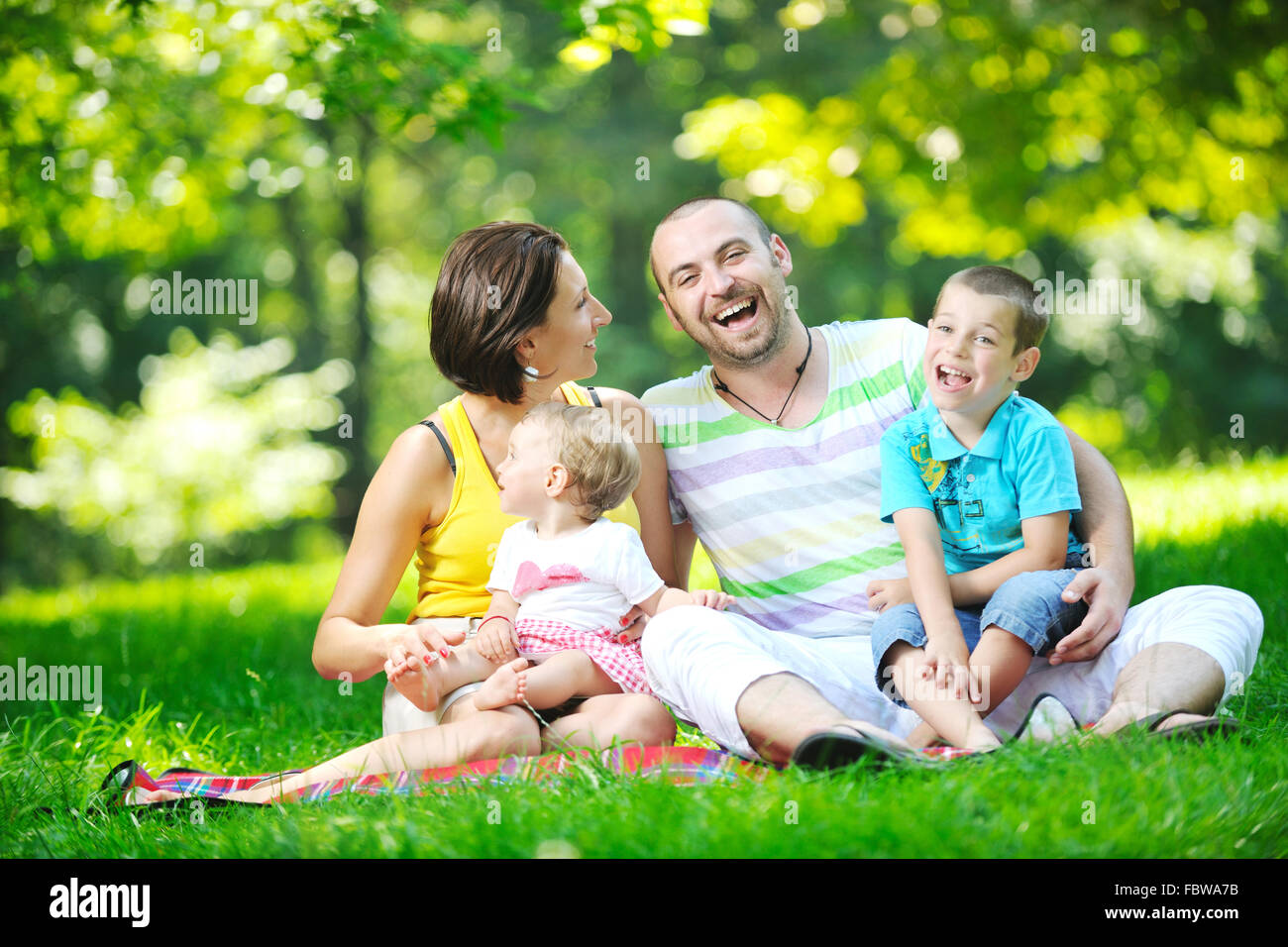 happy young couple with their children have fun at park Stock Photo - Alamy