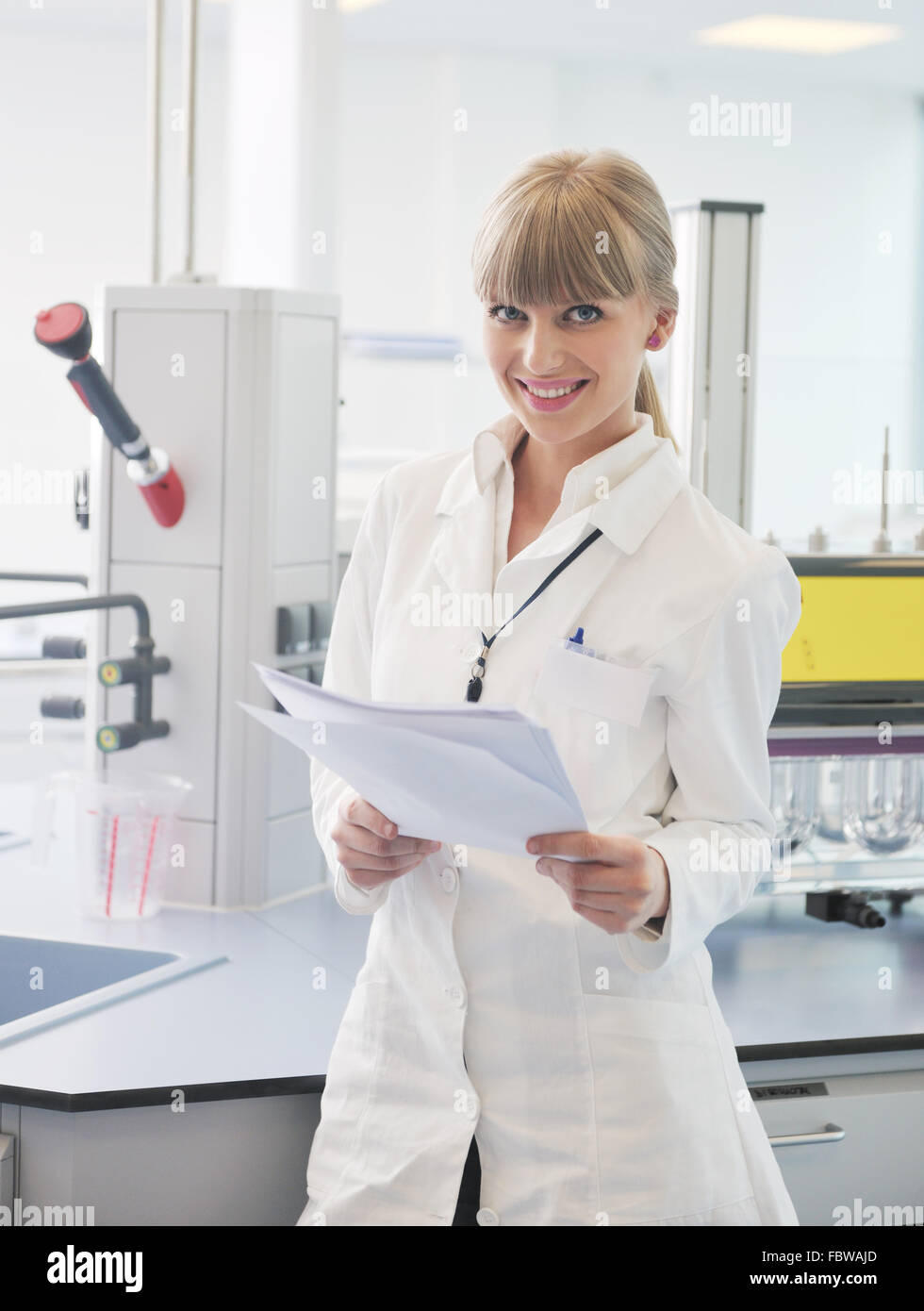 female researcher holding up a test tube in lab Stock Photo - Alamy