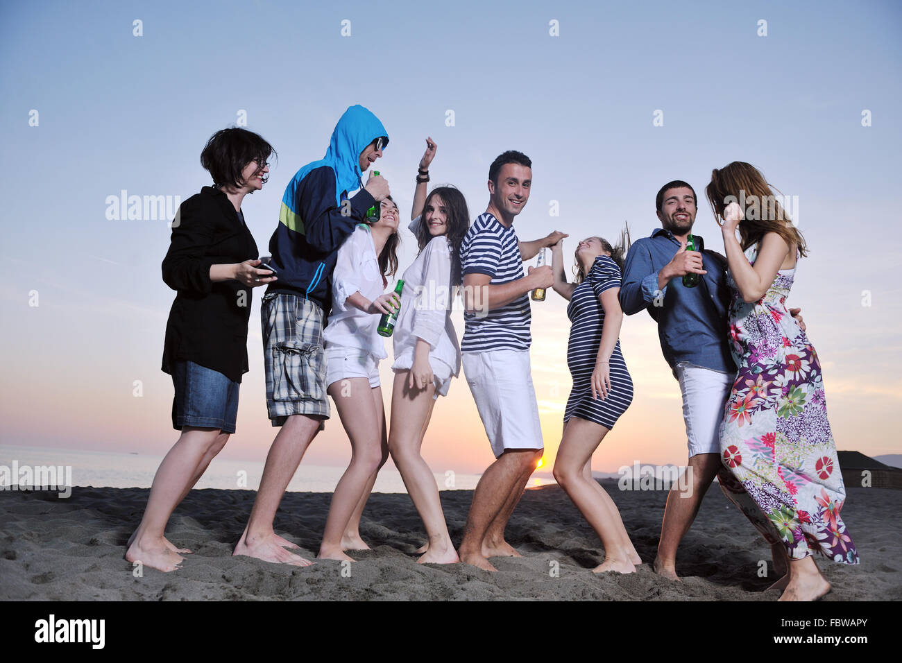 Group of young people enjoy summer party at the beach Stock Photo - Alamy