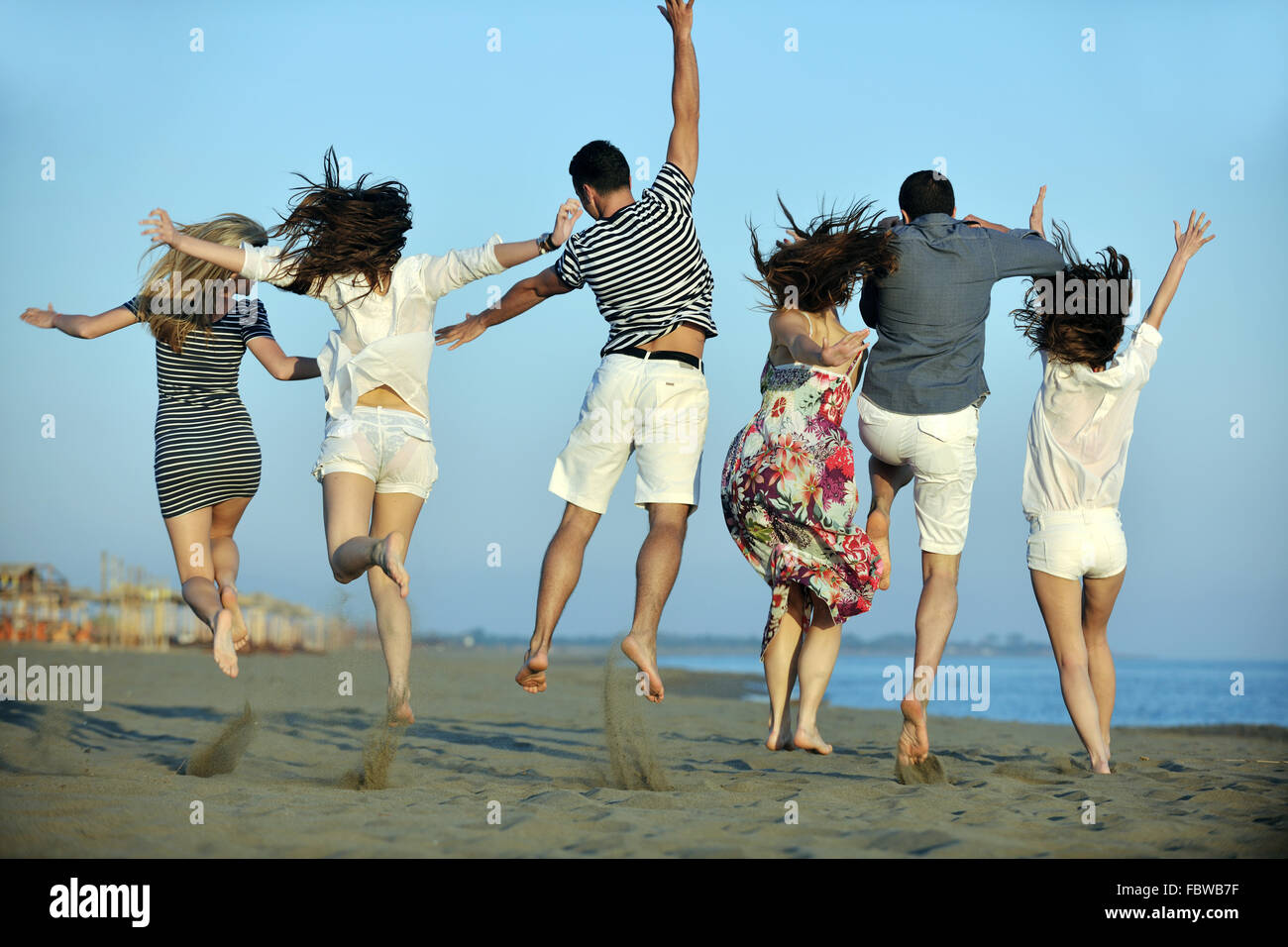 happy young people group have fun on beach Stock Photo - Alamy