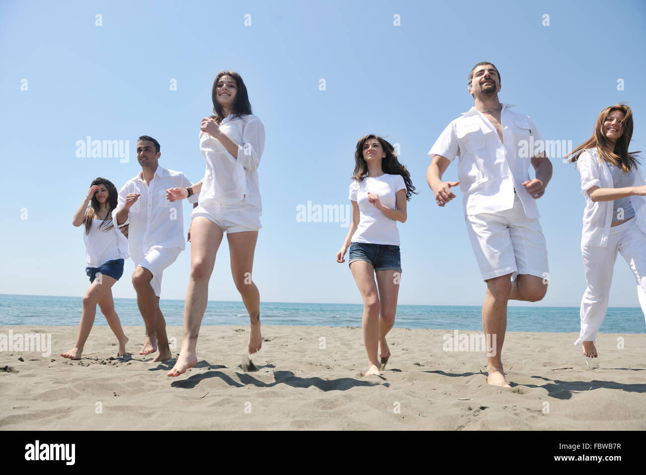 happy people group have fun and running on beach Stock Photo - Alamy