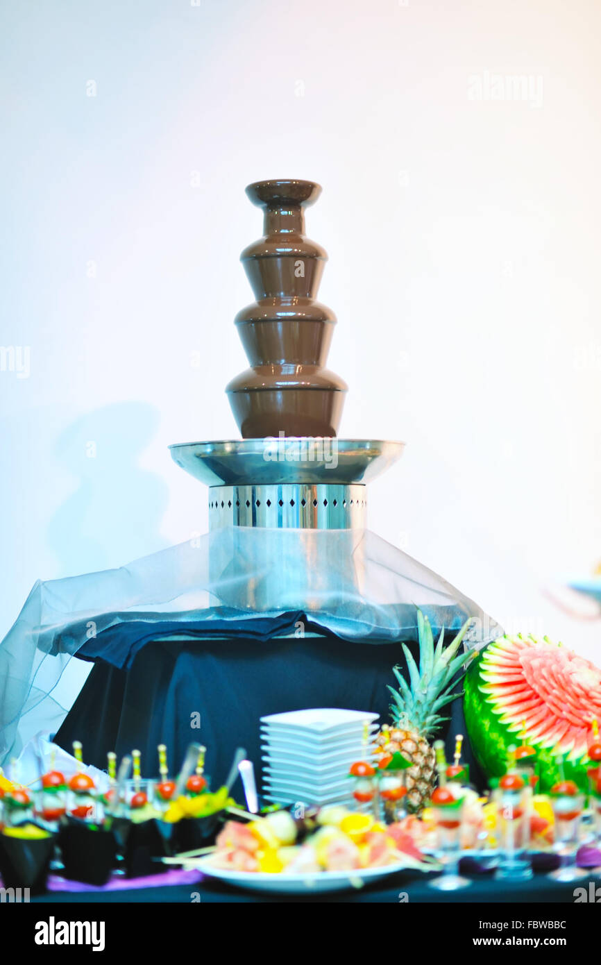 liquid chocolate fountain and fresh fruits on stick Stock Photo - Alamy