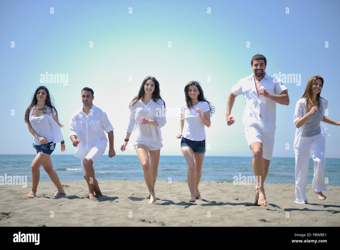 happy people group have fun and running on beach Stock Photo - Alamy