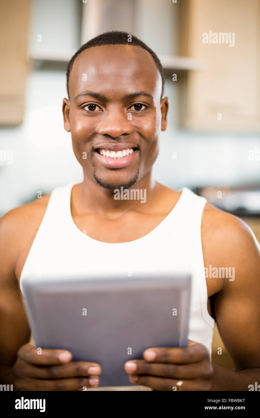 Smiling man holding tablet Stock Photo - Alamy