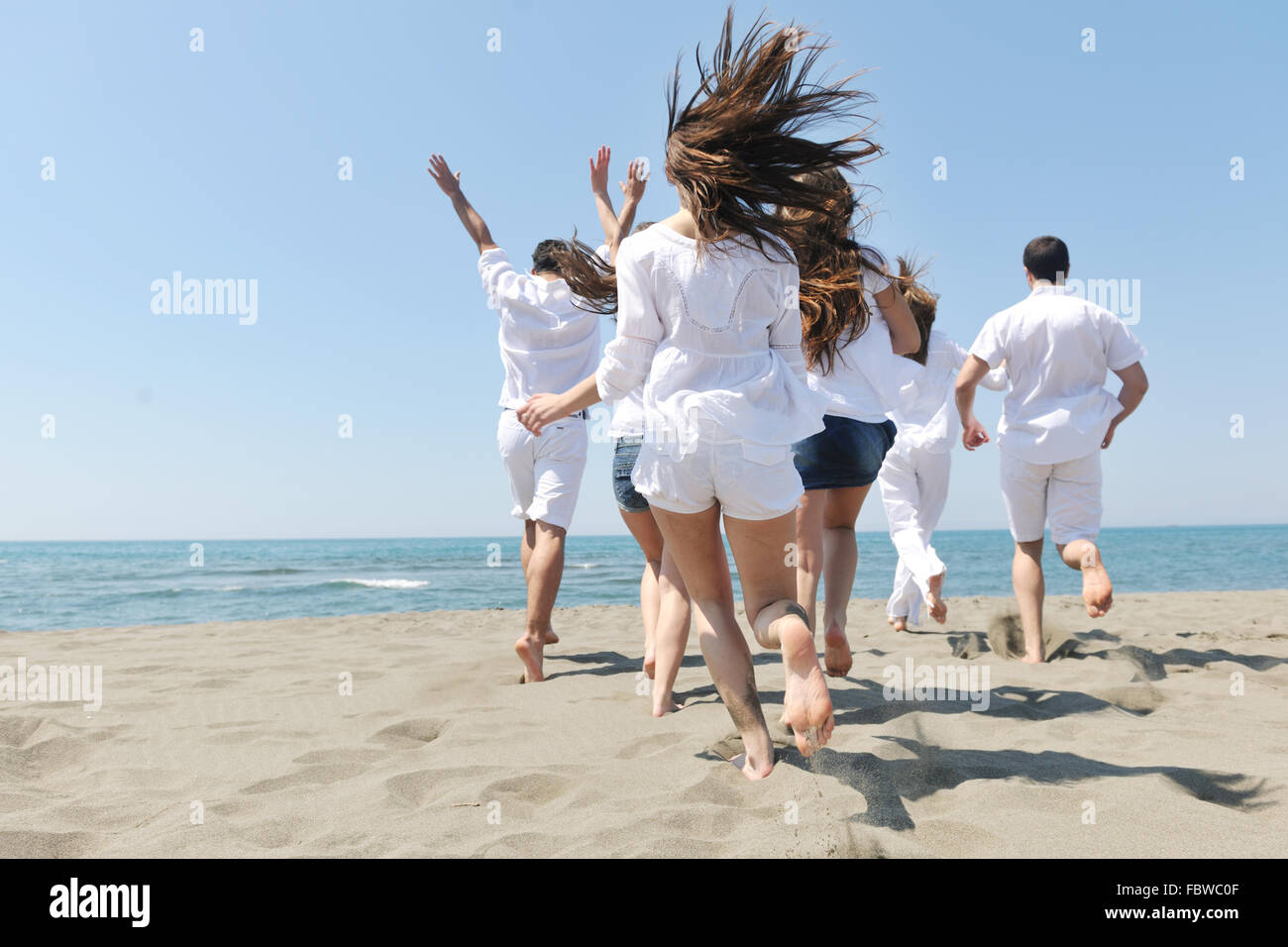 happy people group have fun and running on beach Stock Photo - Alamy