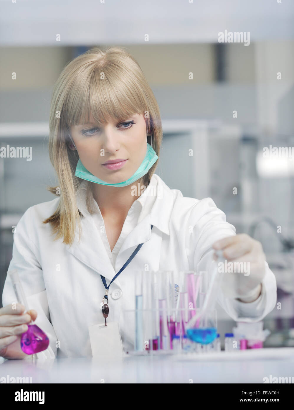 female researcher holding up a test tube in lab Stock Photo - Alamy