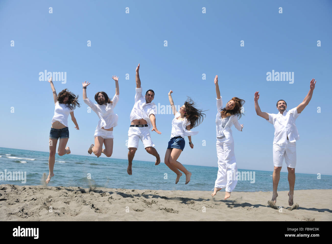 happy people group have fun and running on beach Stock Photo - Alamy