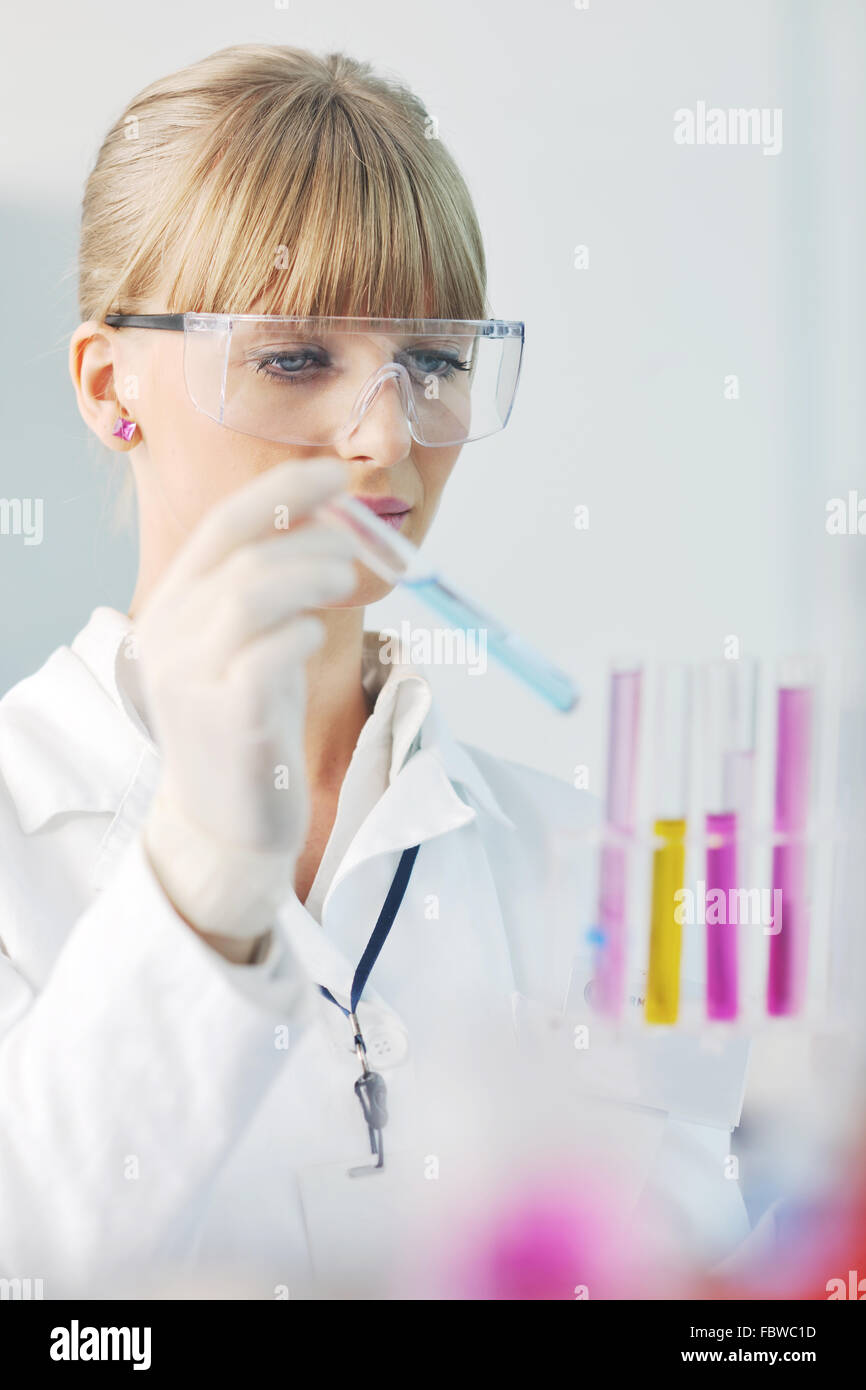 female researcher holding up a test tube in lab Stock Photo - Alamy
